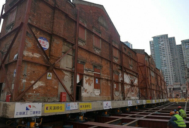 Robots move historic Shikumen buildings back to original site in Shanghai