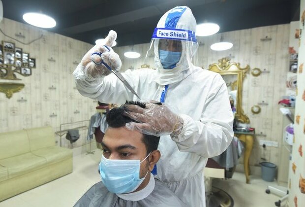 Bangladeshi barbers wearing PPE help quell customers' fears amid pandemic