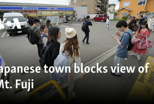 Japanese town blocks view of Mt. Fuji