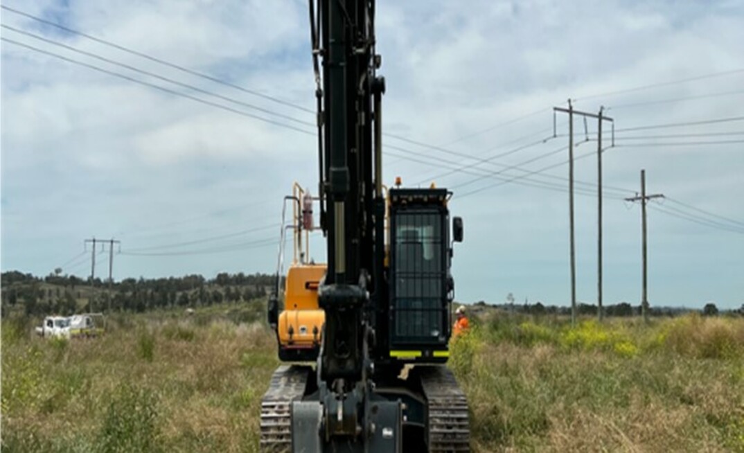 Excavator boom hits power lines