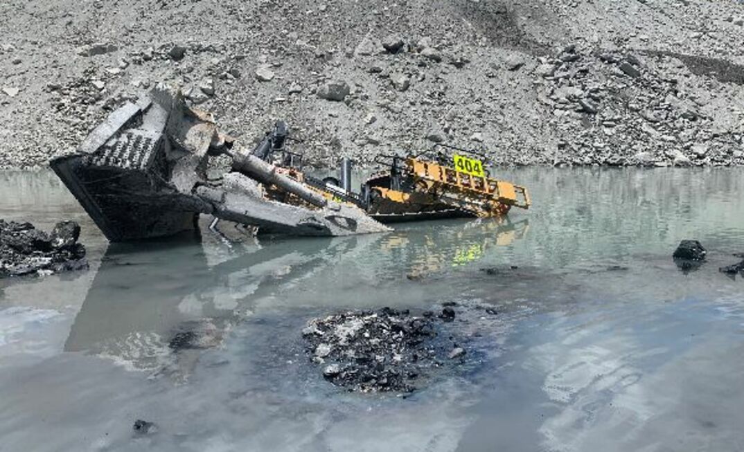 Dozer drops into the drink